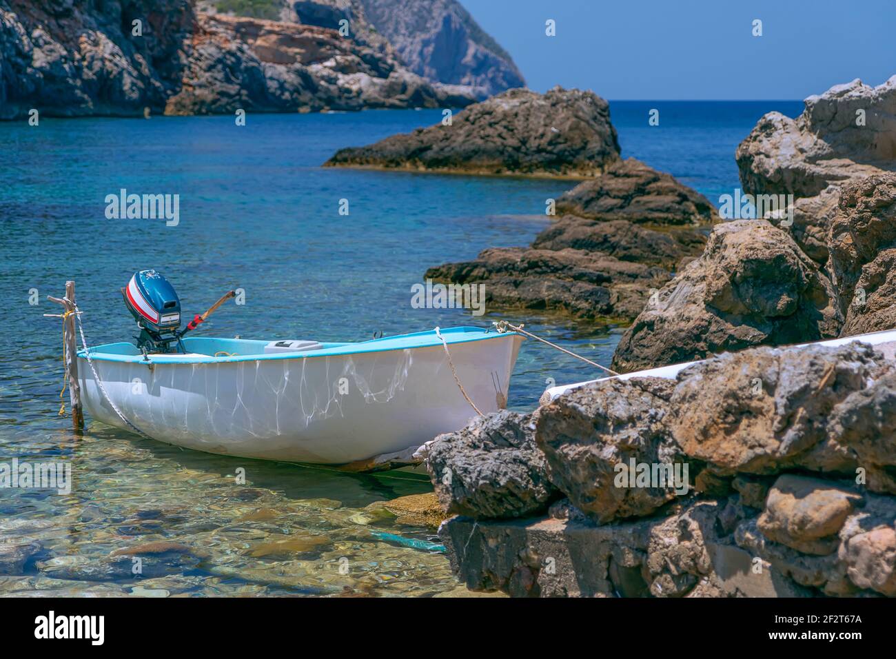 motor fishing boat against the blue sea and rocks (Ibiza, Spain Stock ...