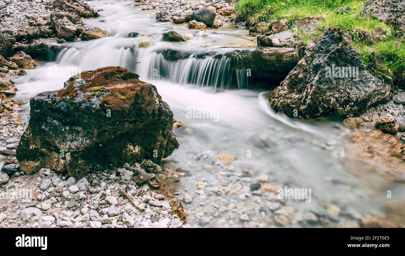 Forest stream running over mossy rocks in Alps (Italian Dolomites Stock ...