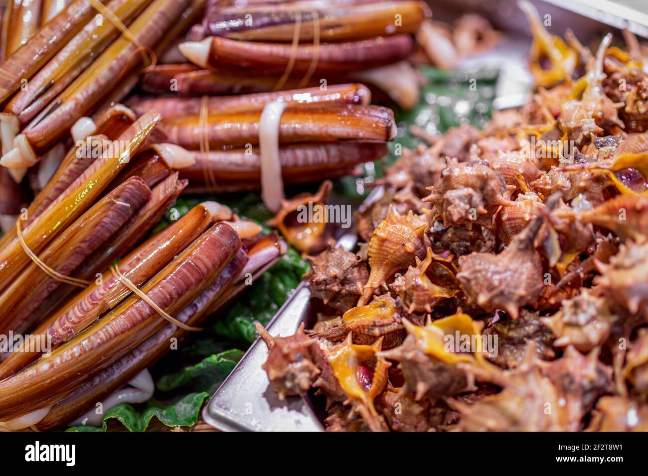 Bunch pile of fresh Razor clams and shells at fish market. Navajas ...