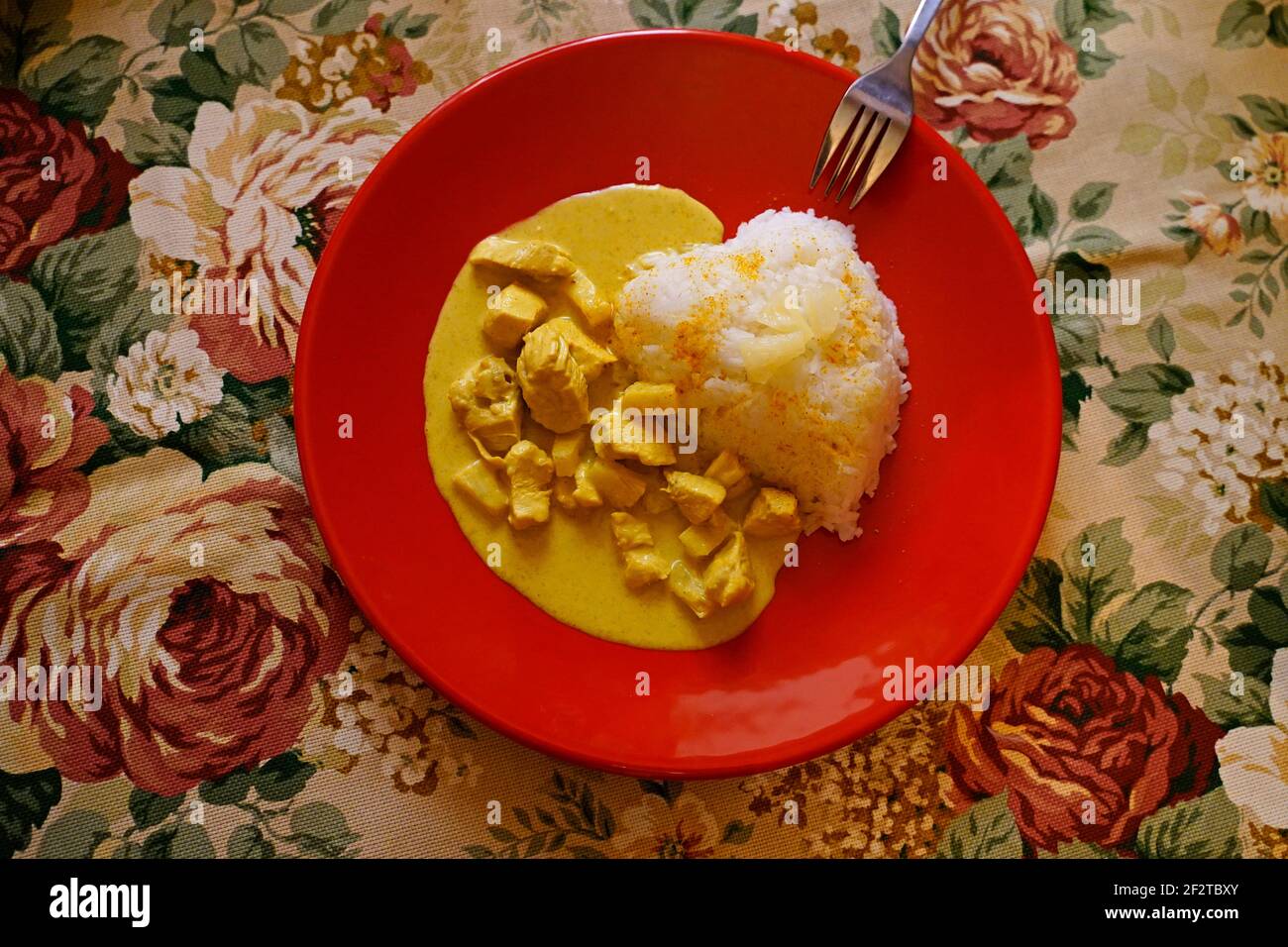 Chicken curry with pineapple and rice on red plate Stock Photo - Alamy