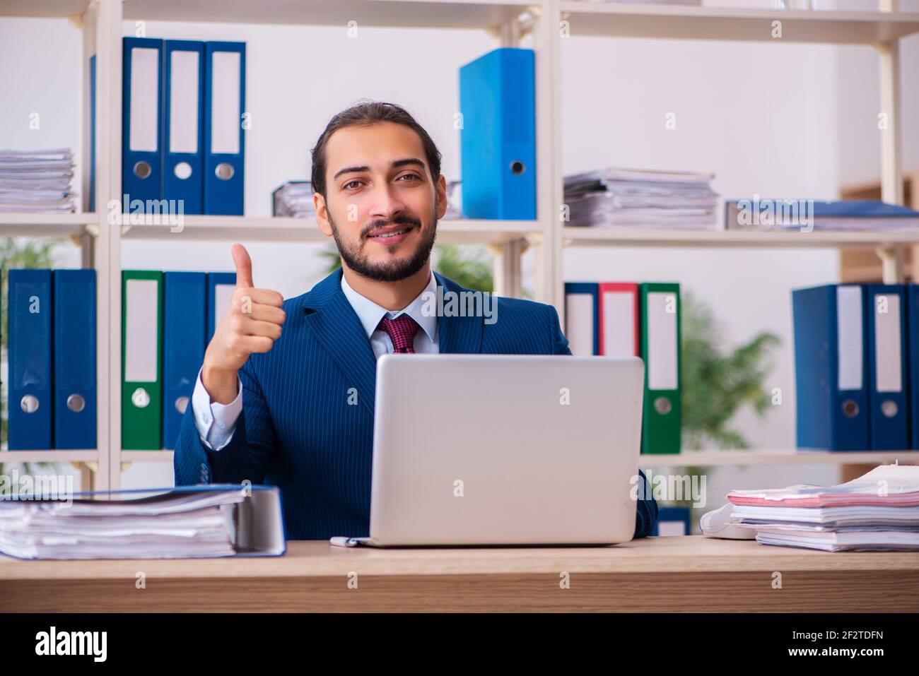 Young employee and too many work in the office Stock Photo - Alamy