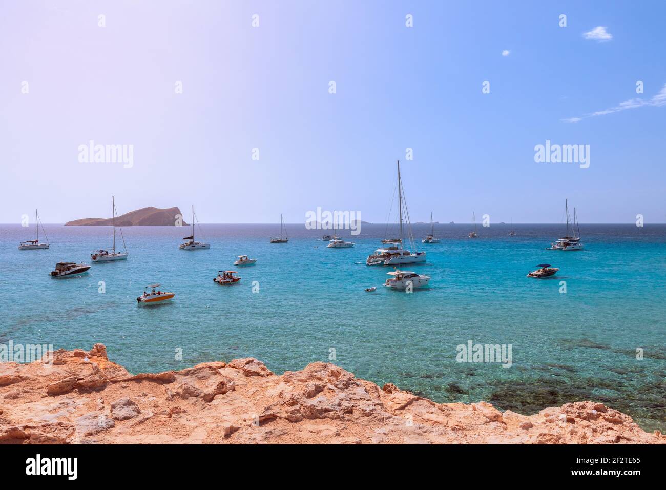Turquoise sea under the bright summer sun of Ibiza, Cala Comte ...