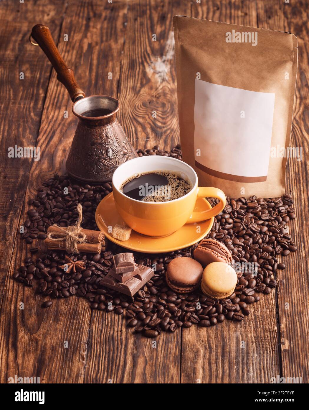 yellow cup of coffee, macaroons, beans, turkish coffee pot, and craft ...