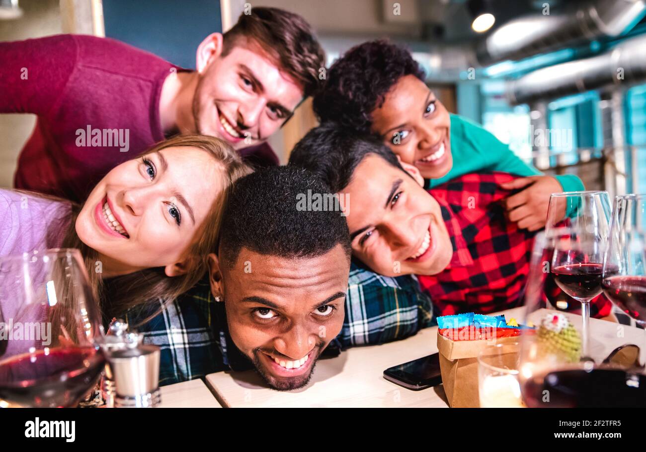 Multiracial friends taking drunk selfie at fancy winery restaurant ...