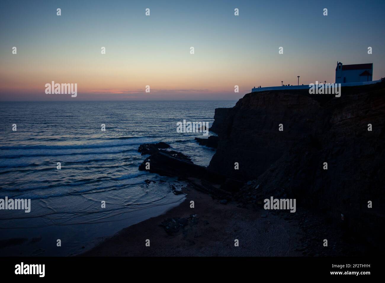 Sunset on the beach of Zambujeira do Mar with a small chapel ...