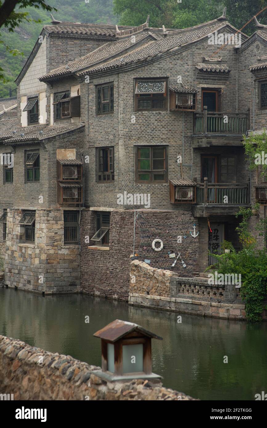 Small and touristic medieval european village on the bank of a river ...