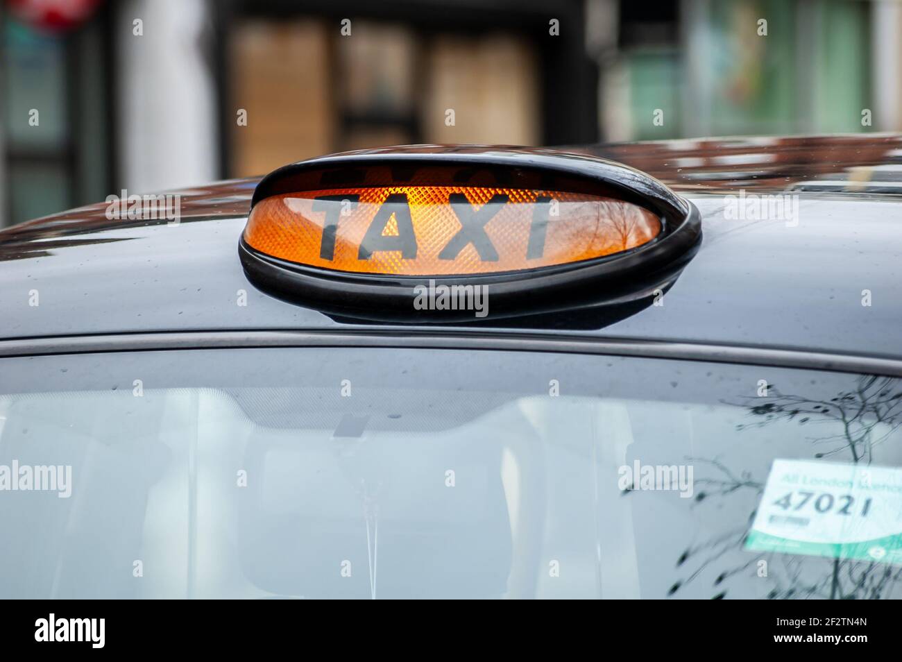 Closeup of London black cab taxi sign Stock Photo - Alamy