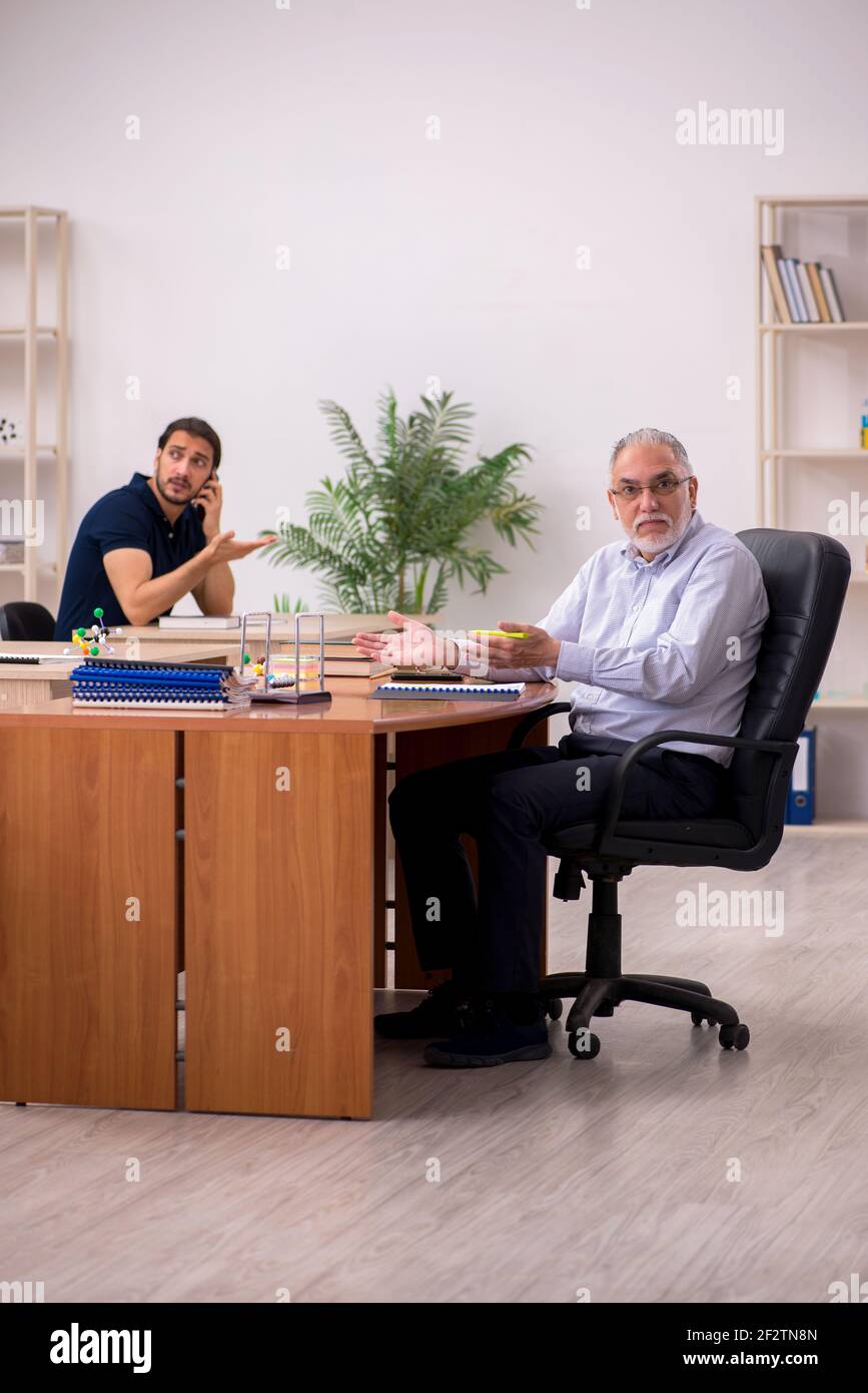 Old male teacher and young student in the classroom Stock Photo - Alamy