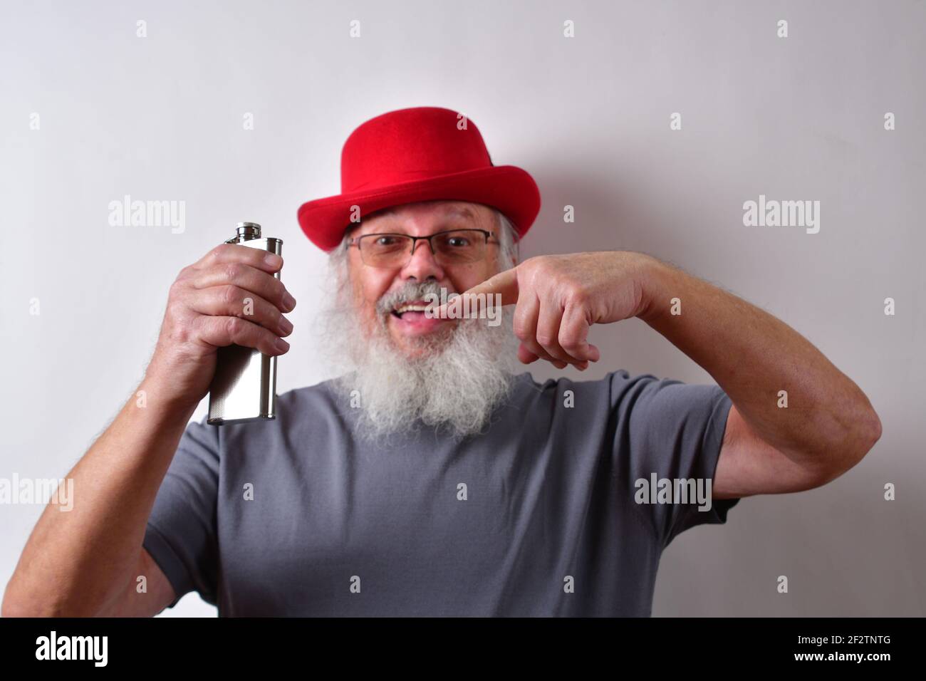 A stylish joyful old man pointing out to a stainless flask in another ...