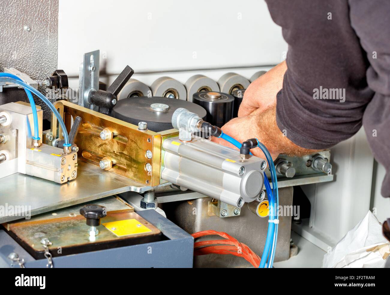 The craftsman makes adjustments of the mechanisms of a modern ...
