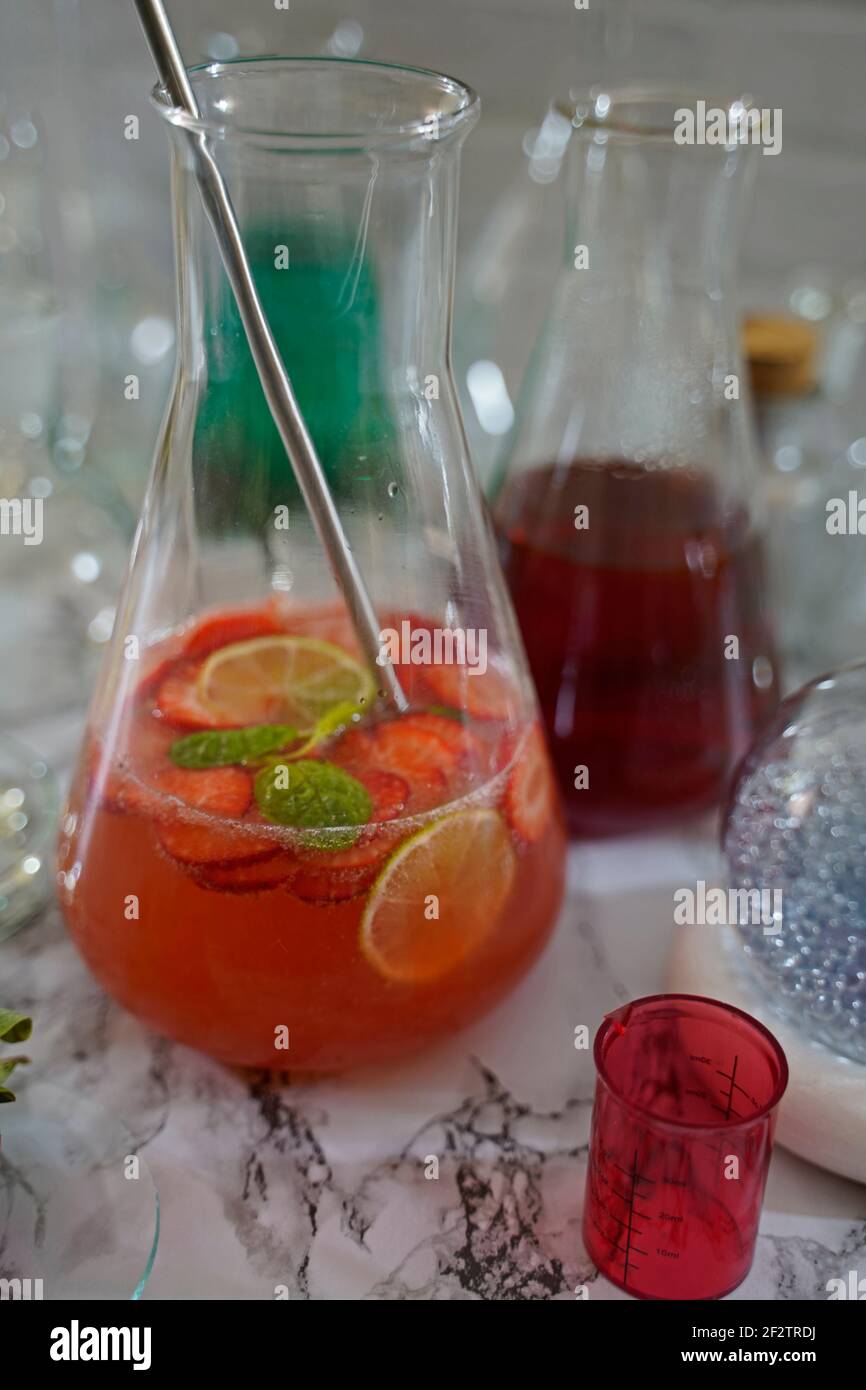 Laboratory punch in a flask. tasty cocktails made and served in the ...