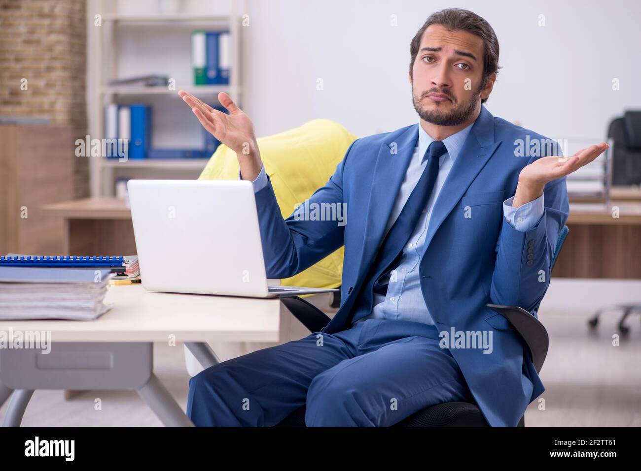 Young male employee looking after new born in the office Stock Photo ...