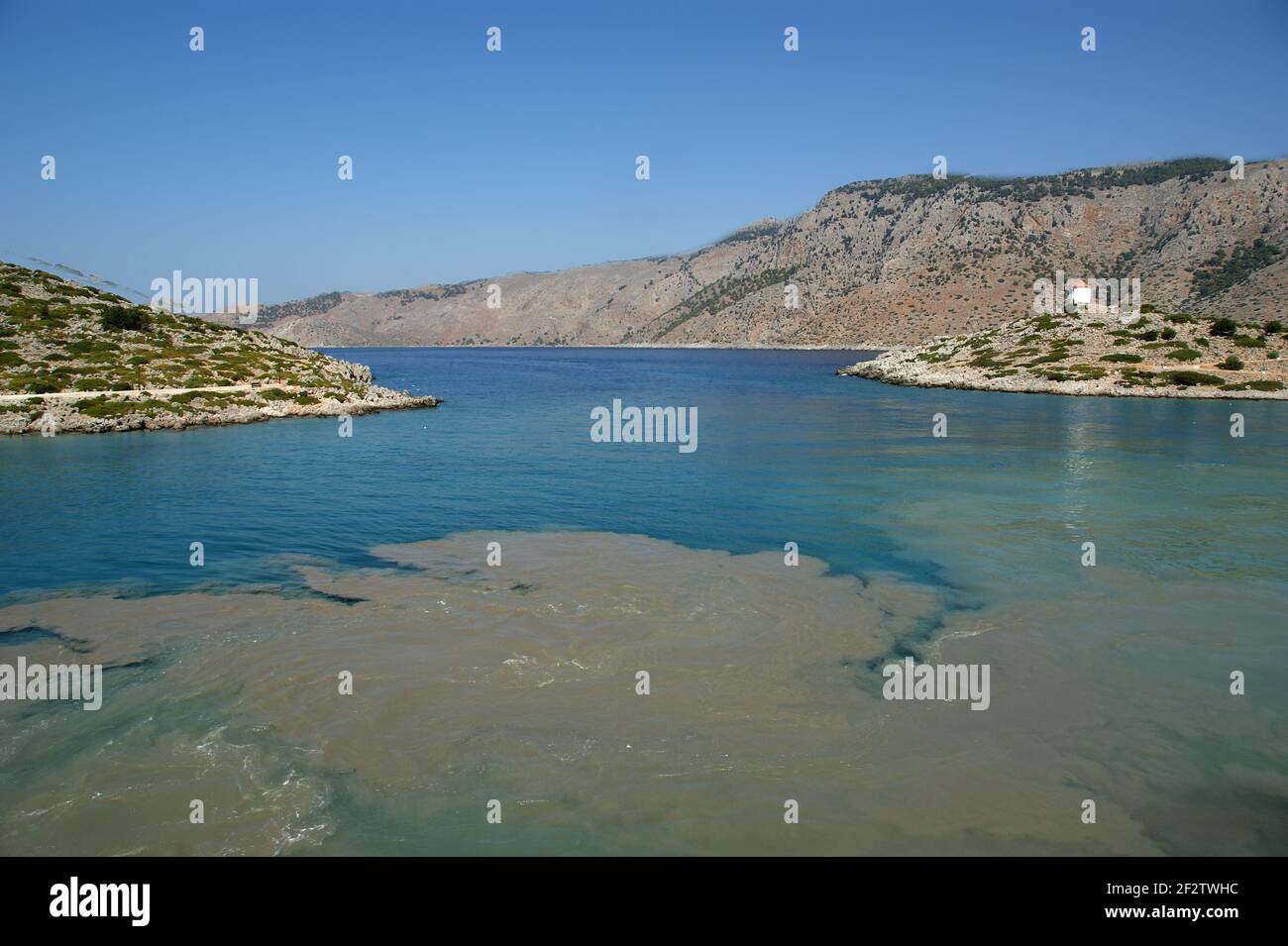 Old windmill on the shore of one of the Greek islands of the Dodecanese ...