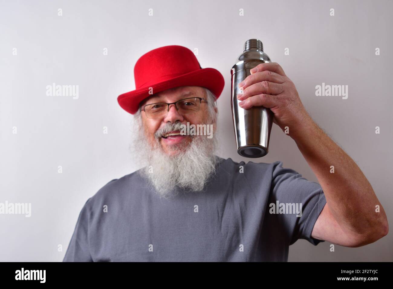 A cheerful American pensioner posing with a cocktail shaker Stock Photo ...