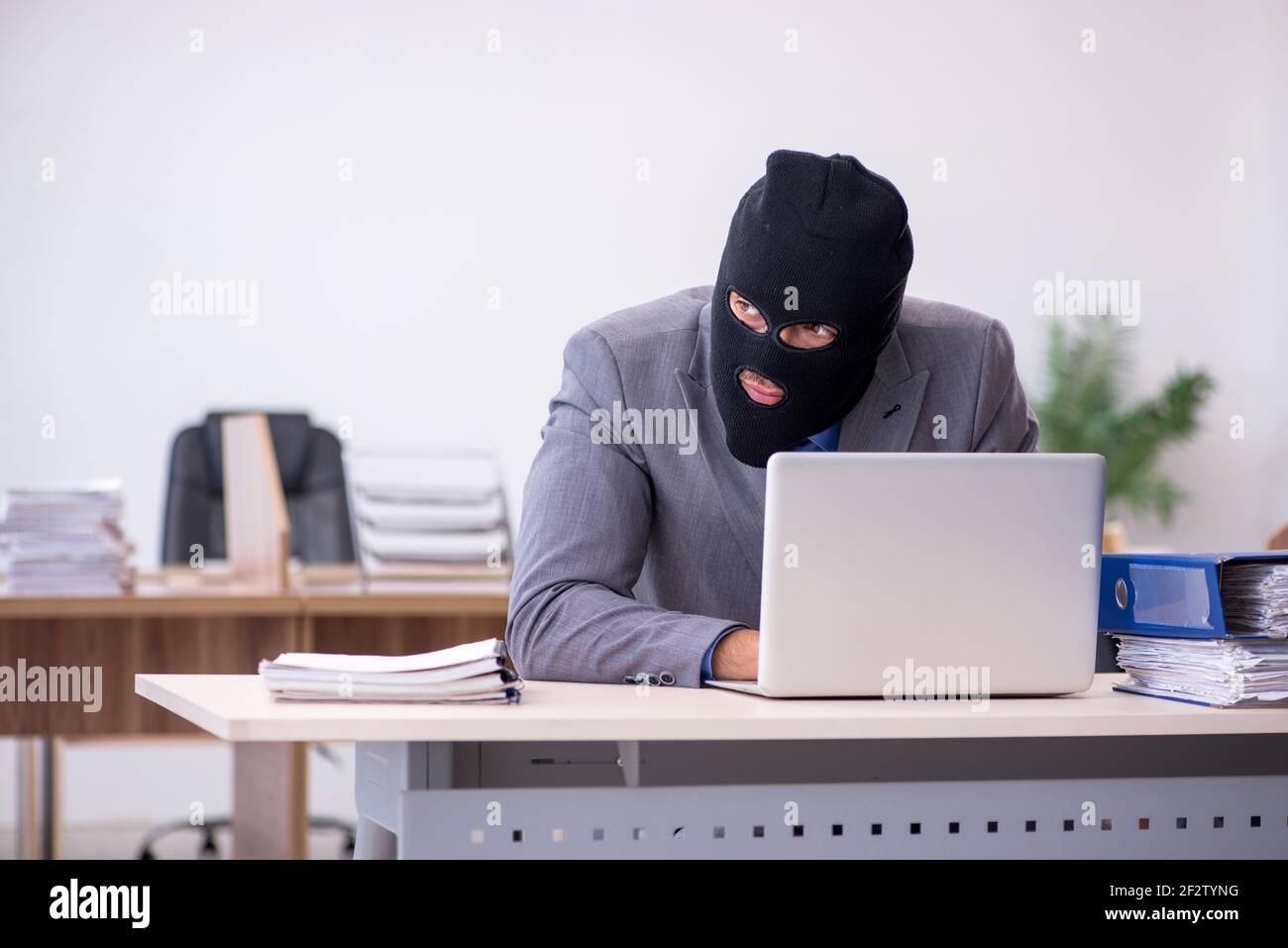 Young employee in industrial espionage concept Stock Photo - Alamy