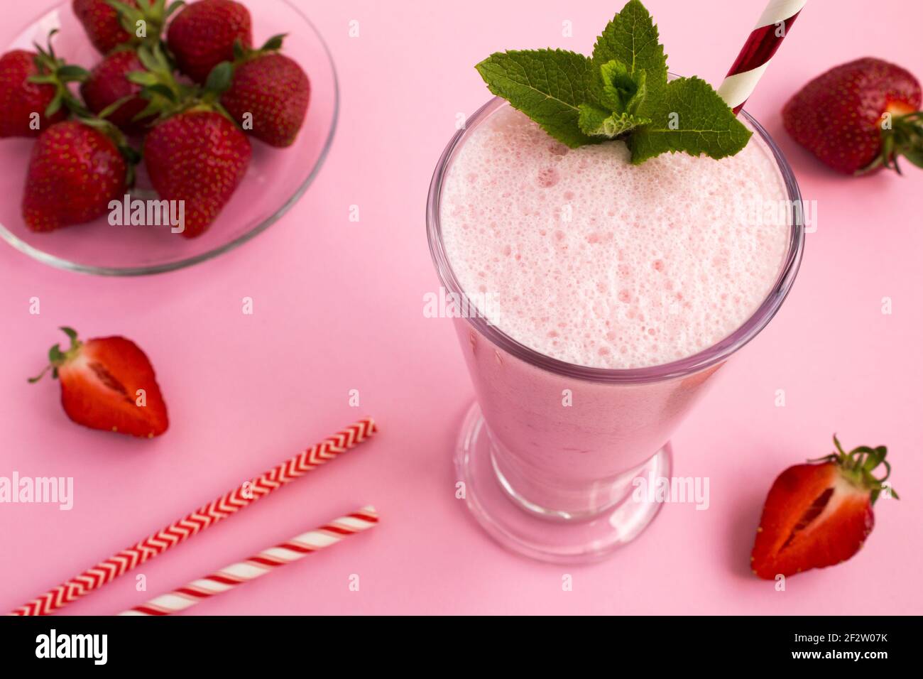 Strawberry milkshake in the glass on the pink background.Top view Stock ...