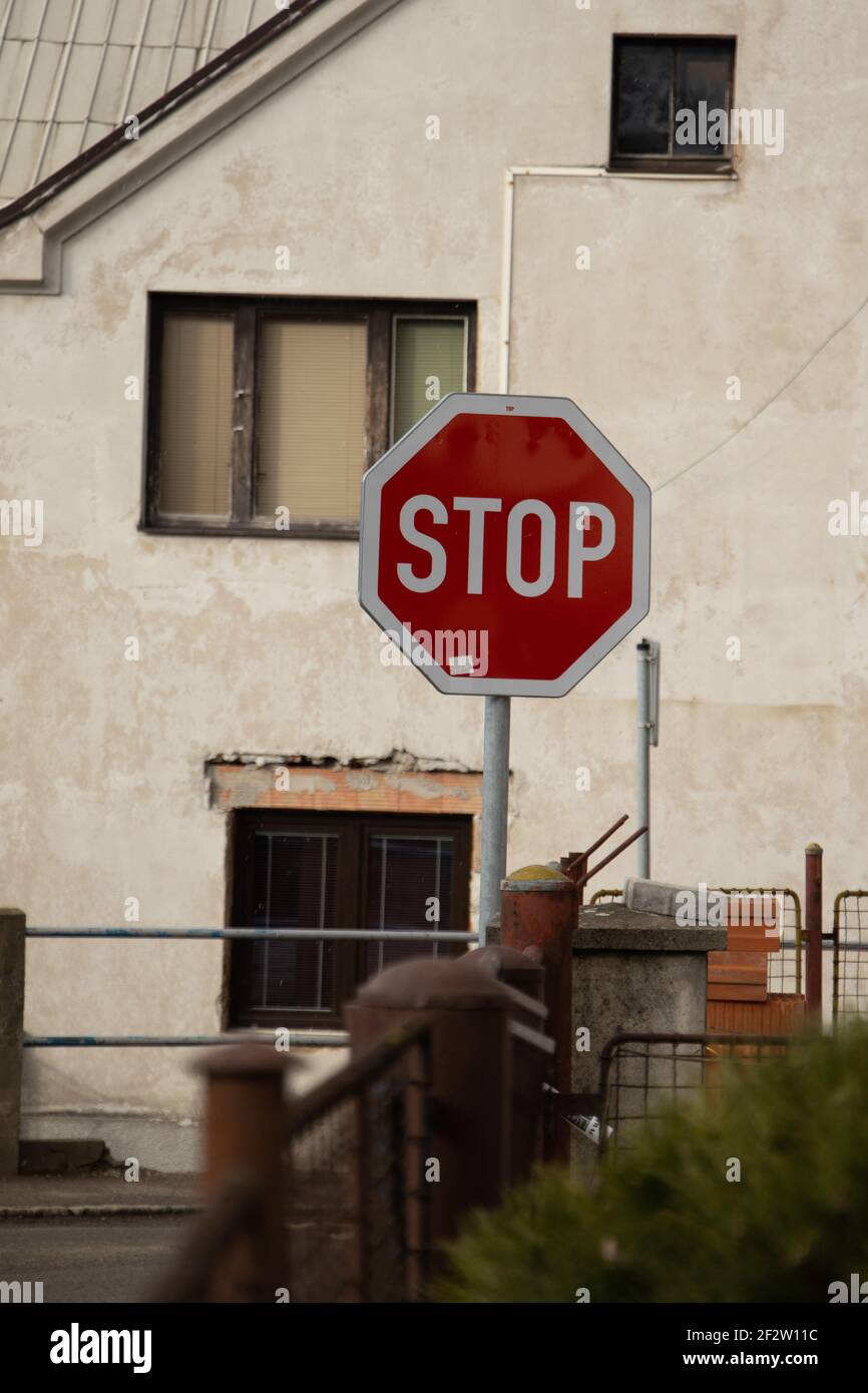A stop sign in front of a building Stock Photo - Alamy