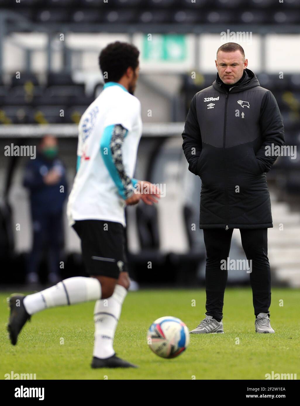 Derby County manager Wayne Rooney (right) watches players warming up ...