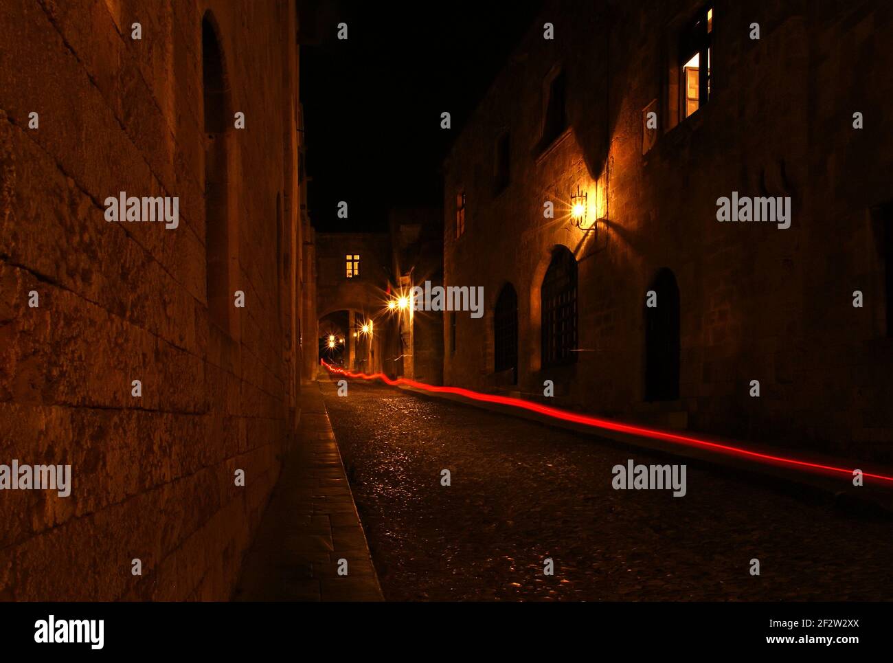 Medieval Avenue of the Knights at night, a cobblestone street in Rhodes ...