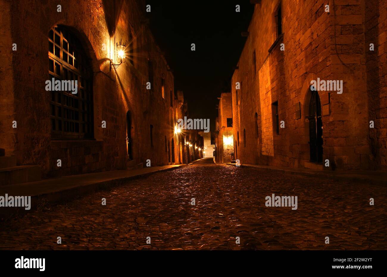 Medieval Avenue of the Knights at night, a cobblestone street in Rhodes ...
