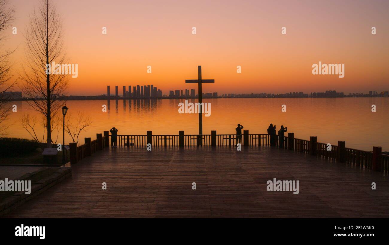 Silhouettes of people seen taking photos at Suzhou Dushu lake during ...