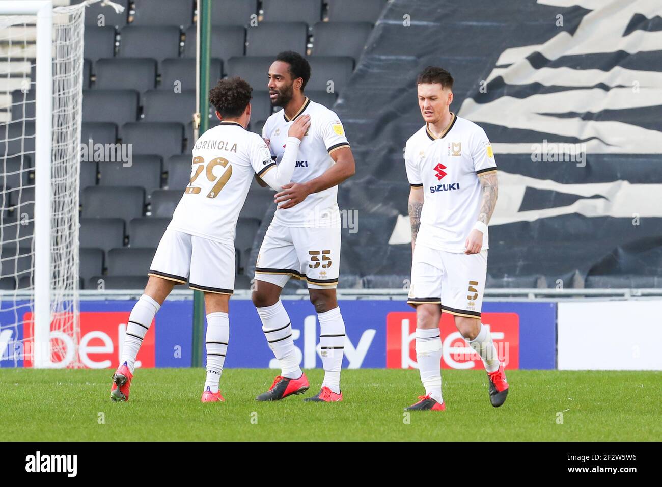 MILTON KEYNES. UK. MARCH 13TH: Cameron Jerome celebrates with team ...