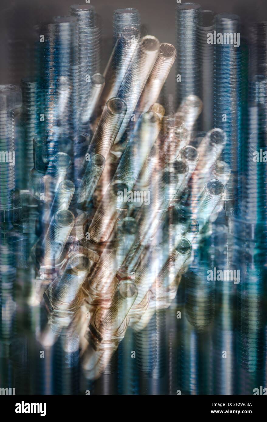 Abstract picture with a group of shiny bolts and nuts on a mirror ...