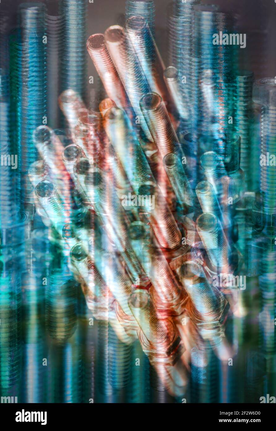 Abstract picture with a group of shiny bolts and nuts on a mirror ...