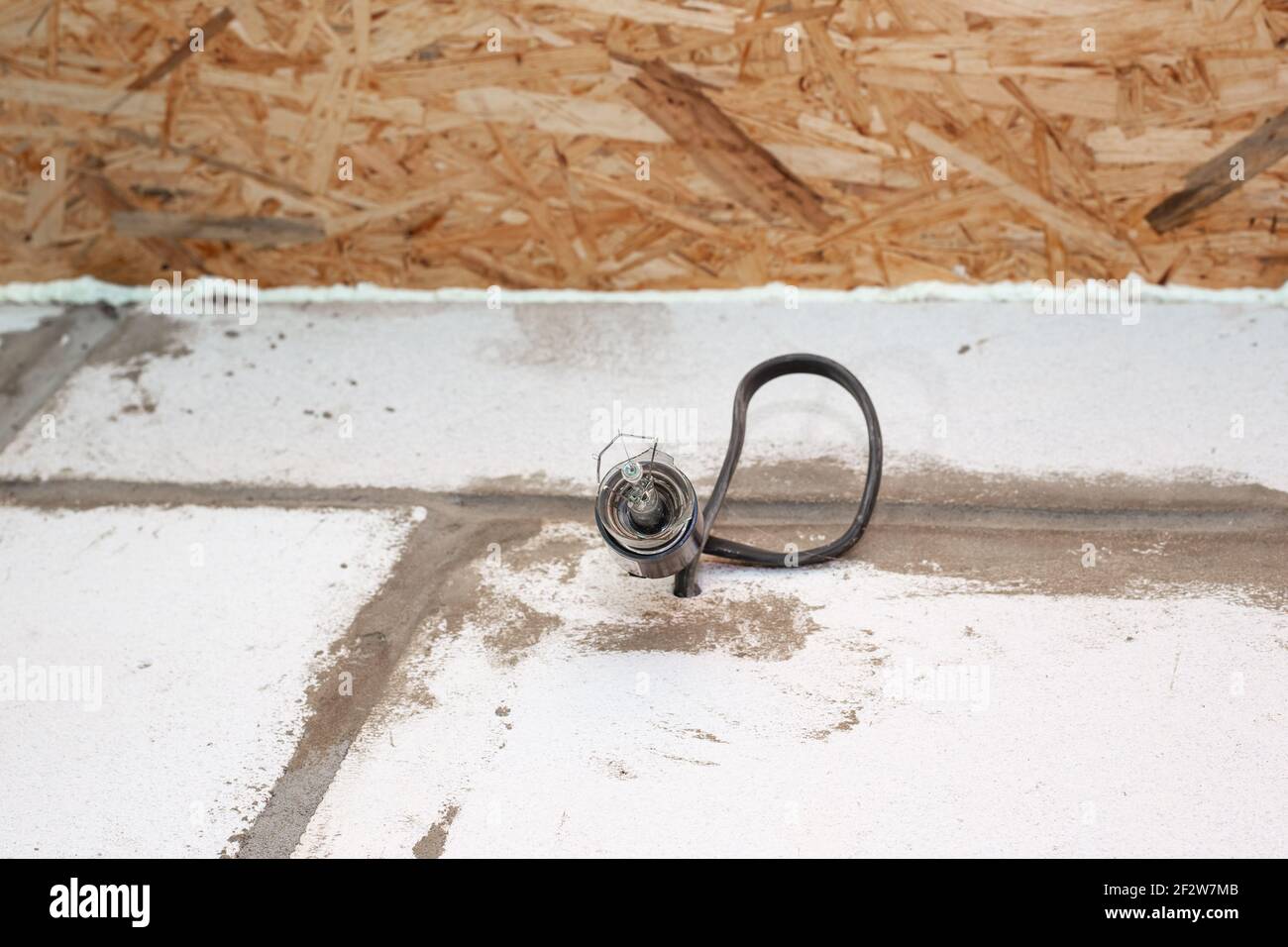 On the wall in an electric socket are fragments of a bursting light ...