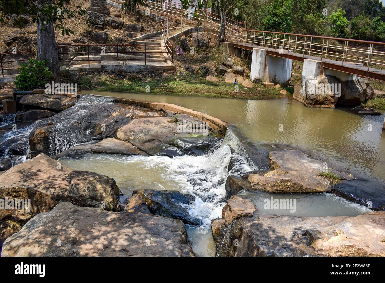 Small water reservoir in stone mountain with bridge for communication ...