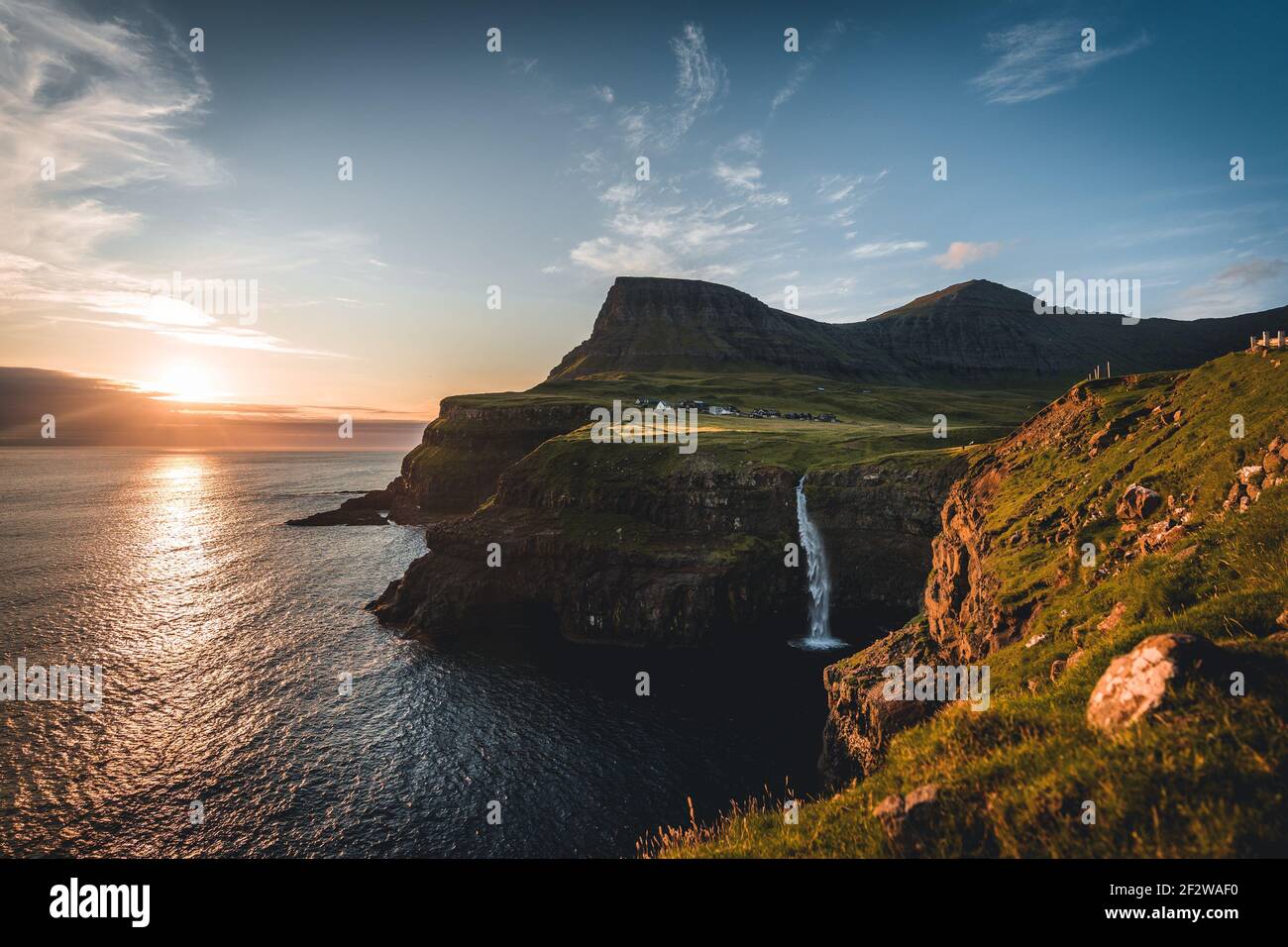 Gasadalur village and Mulafossur its iconic waterfall during summer ...