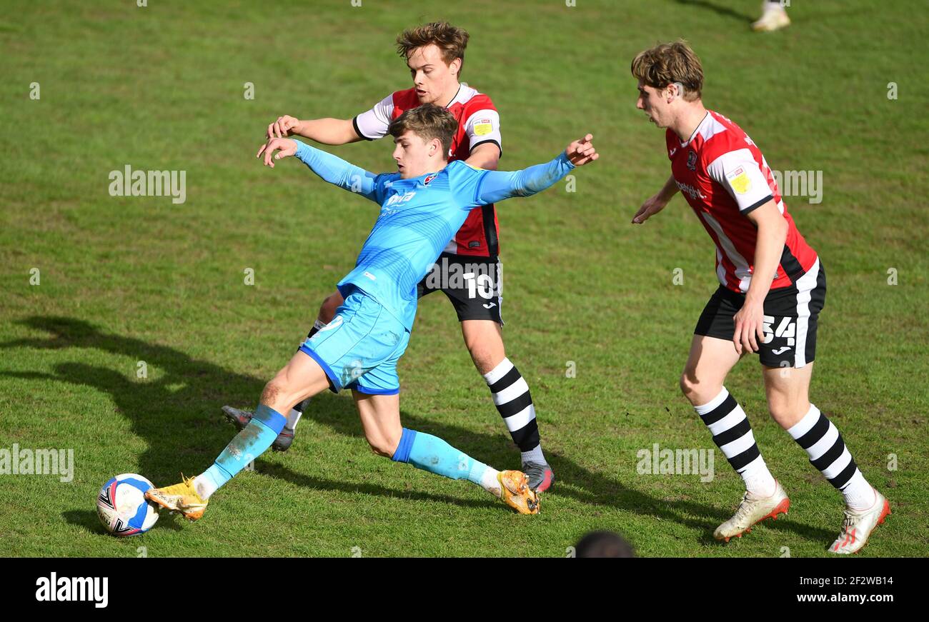 Cheltenham Town's George Lloyd (left) and Exeter City's Archie Collins ...