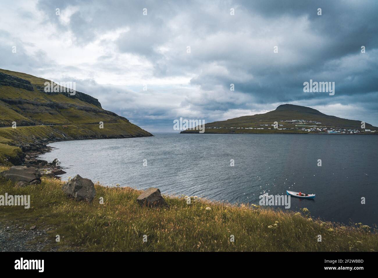 Two traditional boat with fisherman in a natural harbour, Faroe Island ...