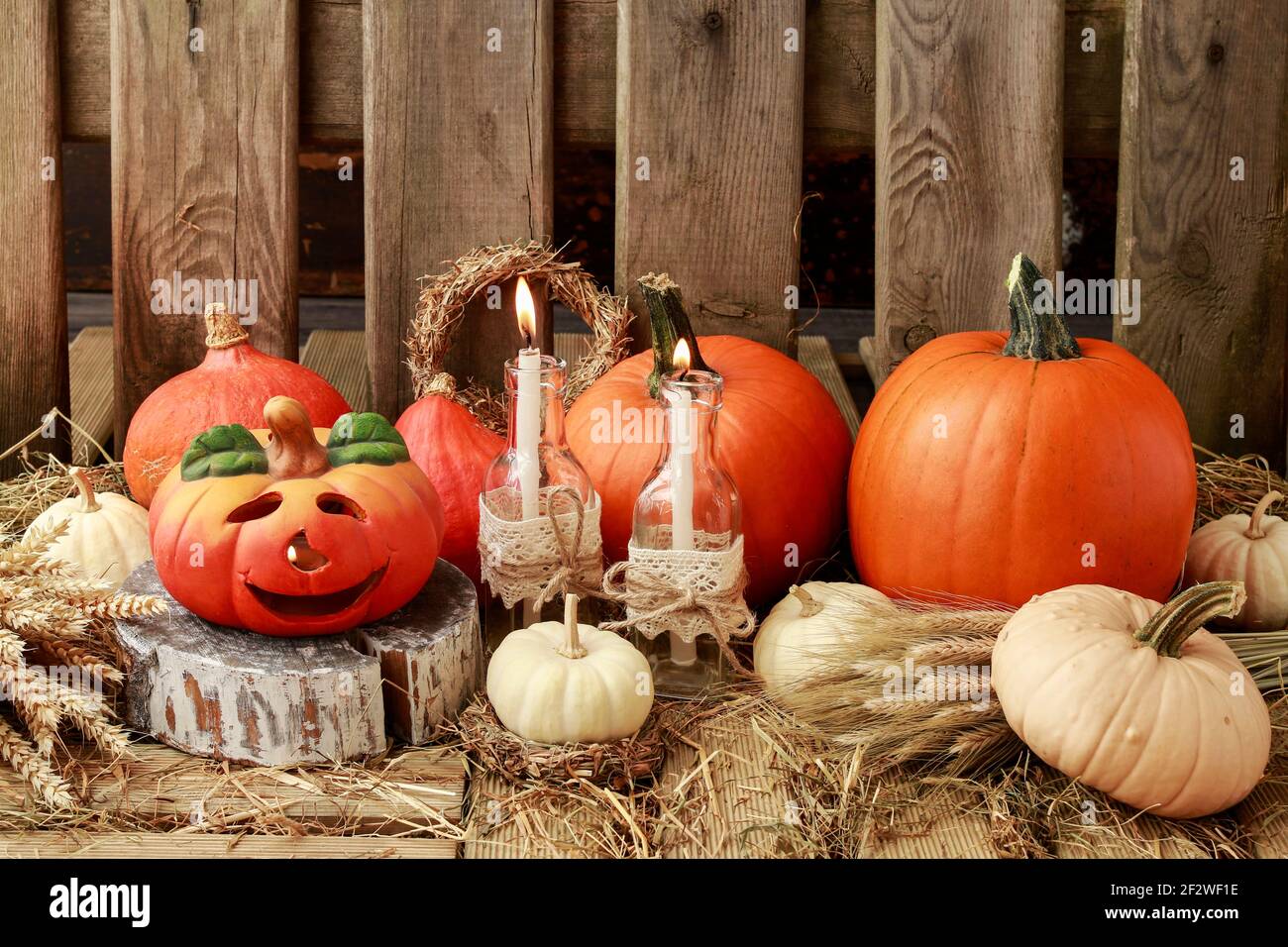 Autumn decorations with pumpkins, hay, leaves and beautiful lanterns ...