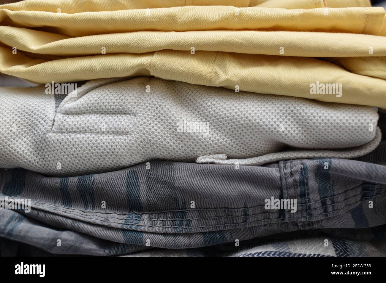 shot of Stack of folded cotton clothes in horizontal frame .Front view ...