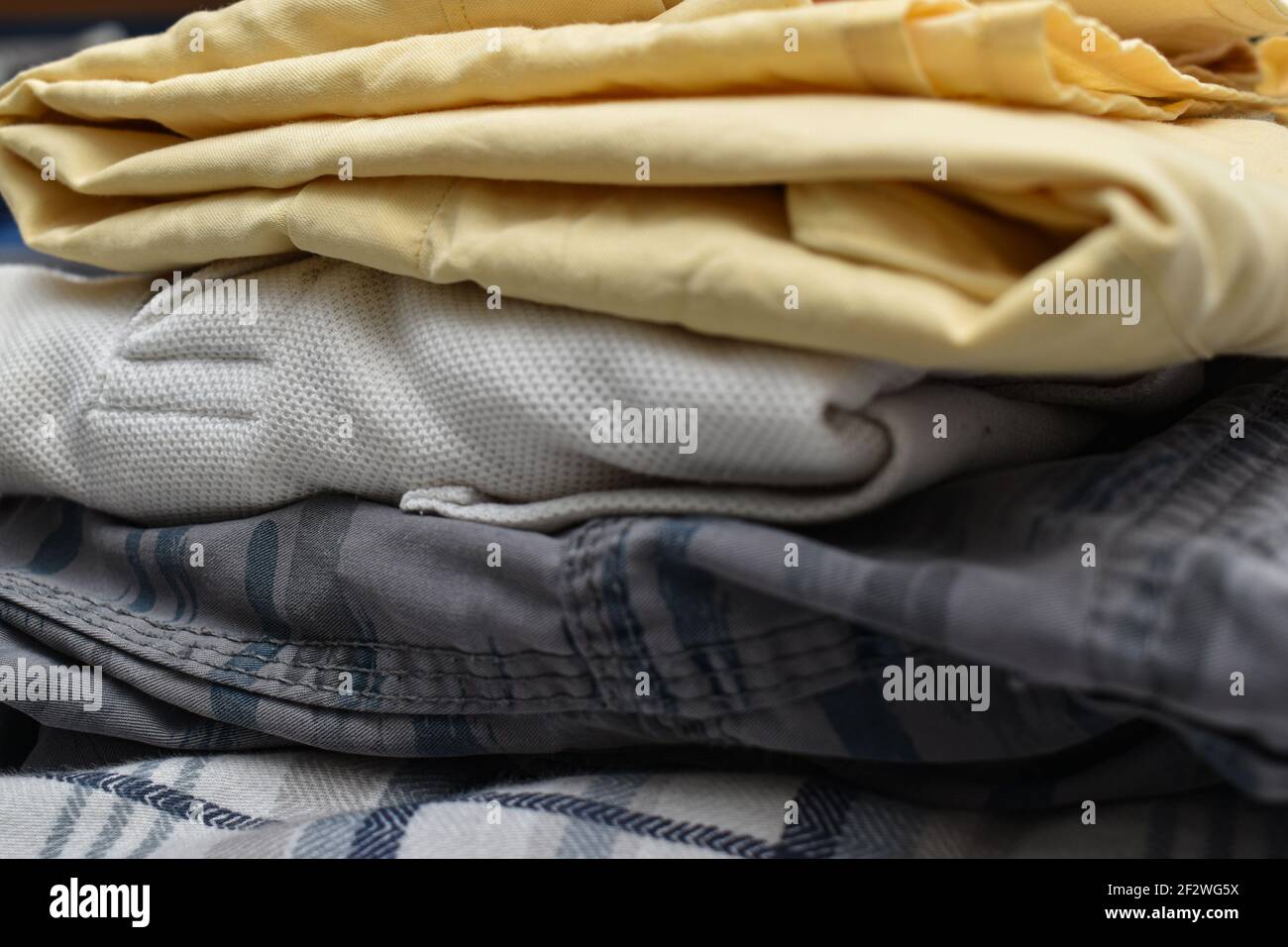 closeup shot of Stack of folded cotton clothes in horizontal frame ...
