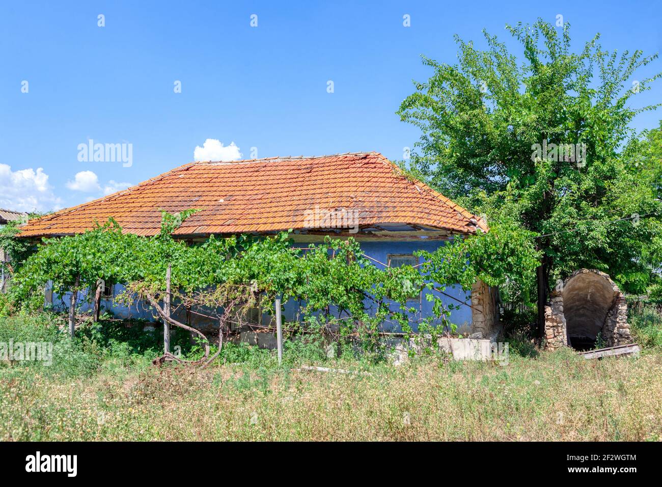 Old abandoned hose with tiled roof in the village . Ancient hovel and ...