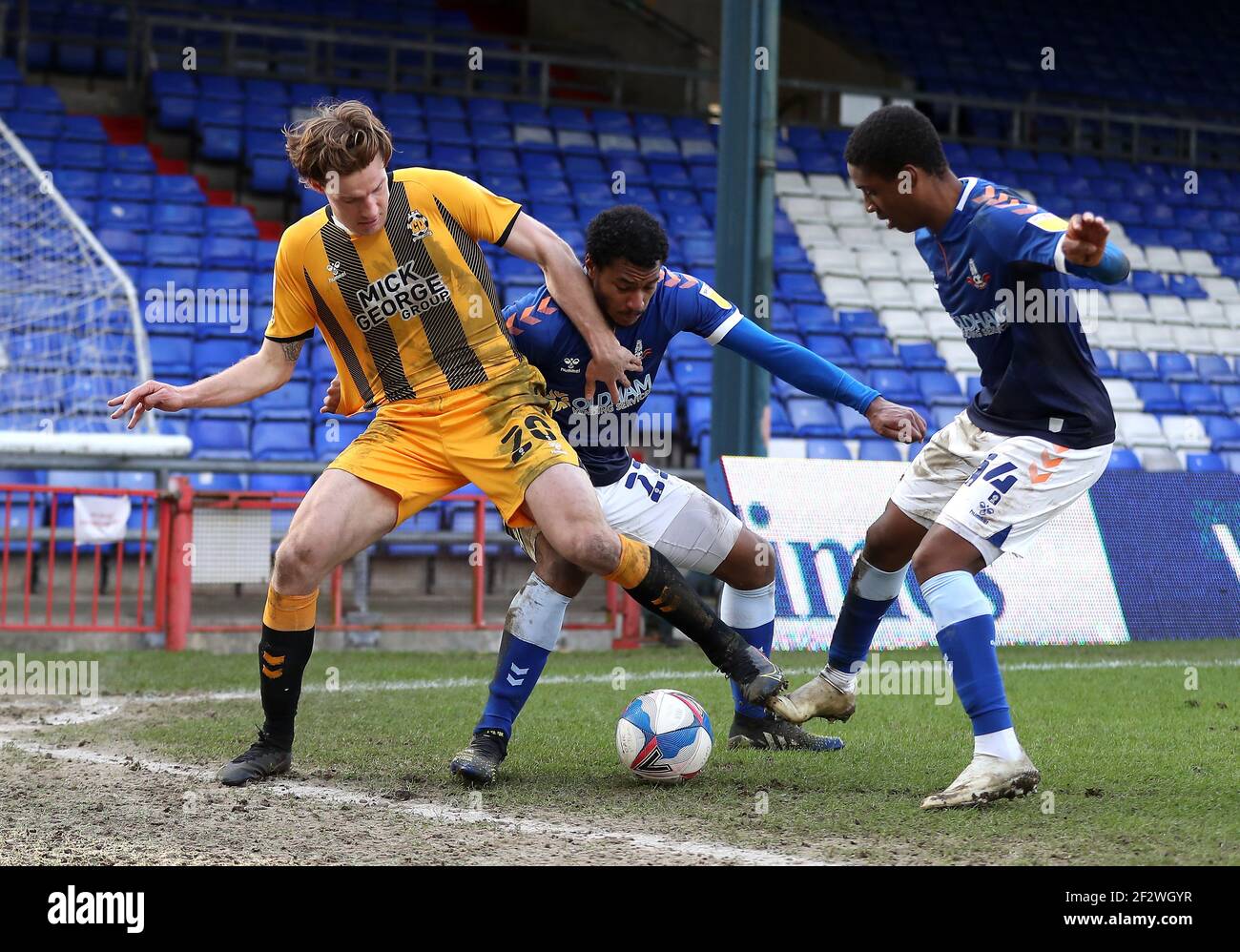 Cambridge United's Joe Ironside (left) battles for the ball with Oldham ...