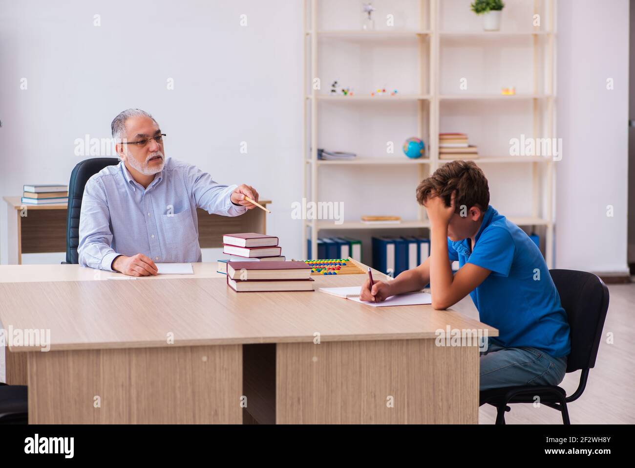 Boy taking book classroom hi-res stock photography and images - Alamy