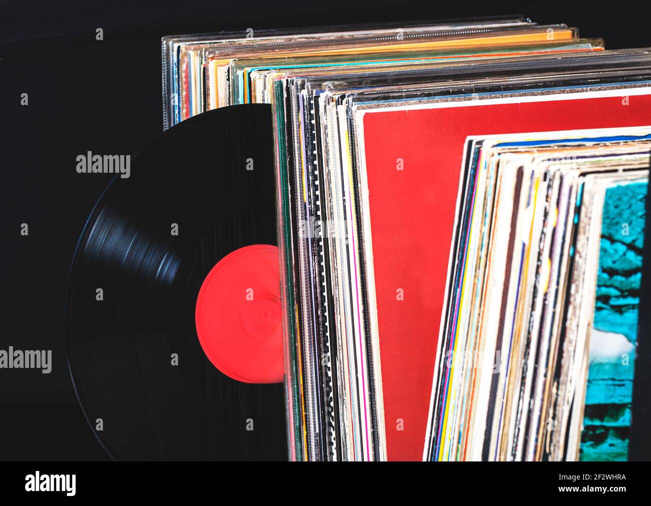 a record is peeking out of a pile of records Stock Photo - Alamy