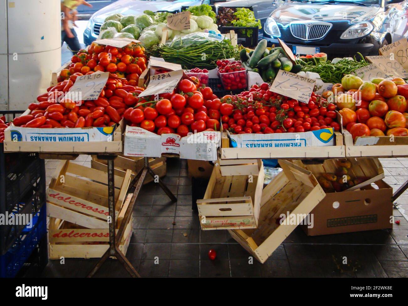 Market stall with all kinds of tomatoes on a market in Italy. There are ...