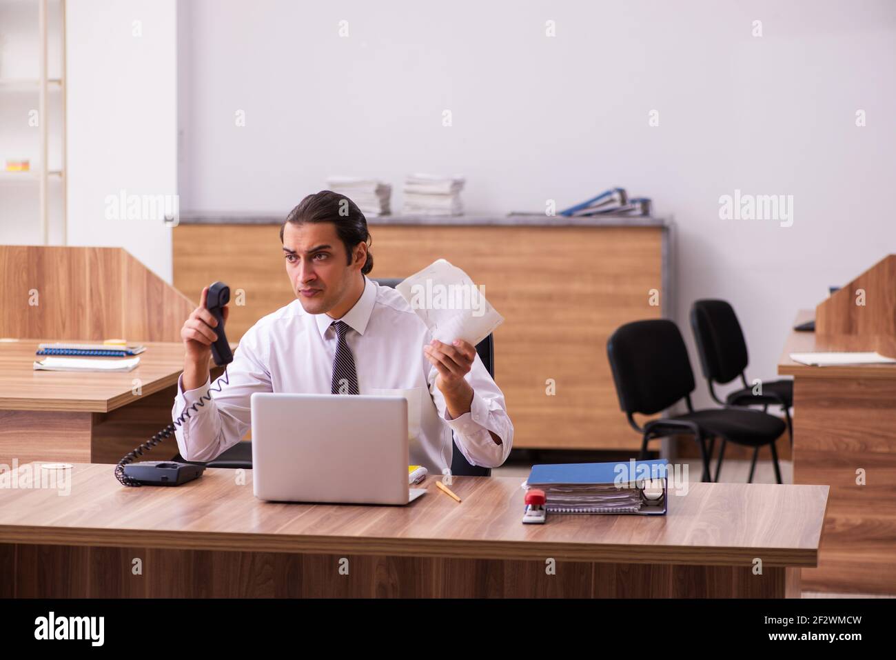 Young businessman employee unhappy with office prank in the office ...
