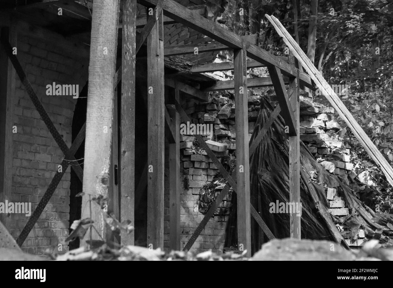Abandoned brick building with a frame made of wooden planks. Just ...