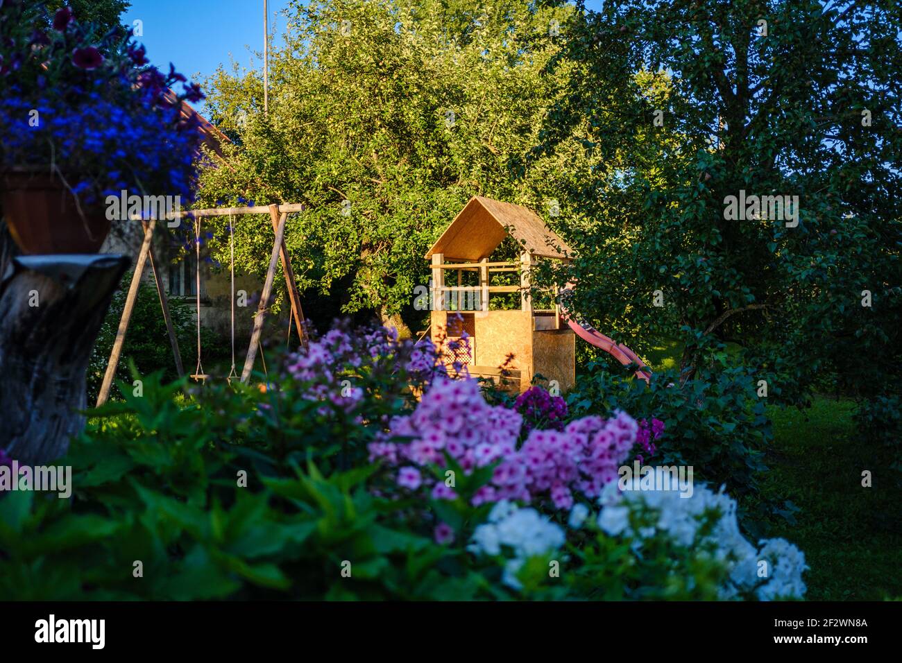 countryside house garden backyard in summer with old buildings and ...