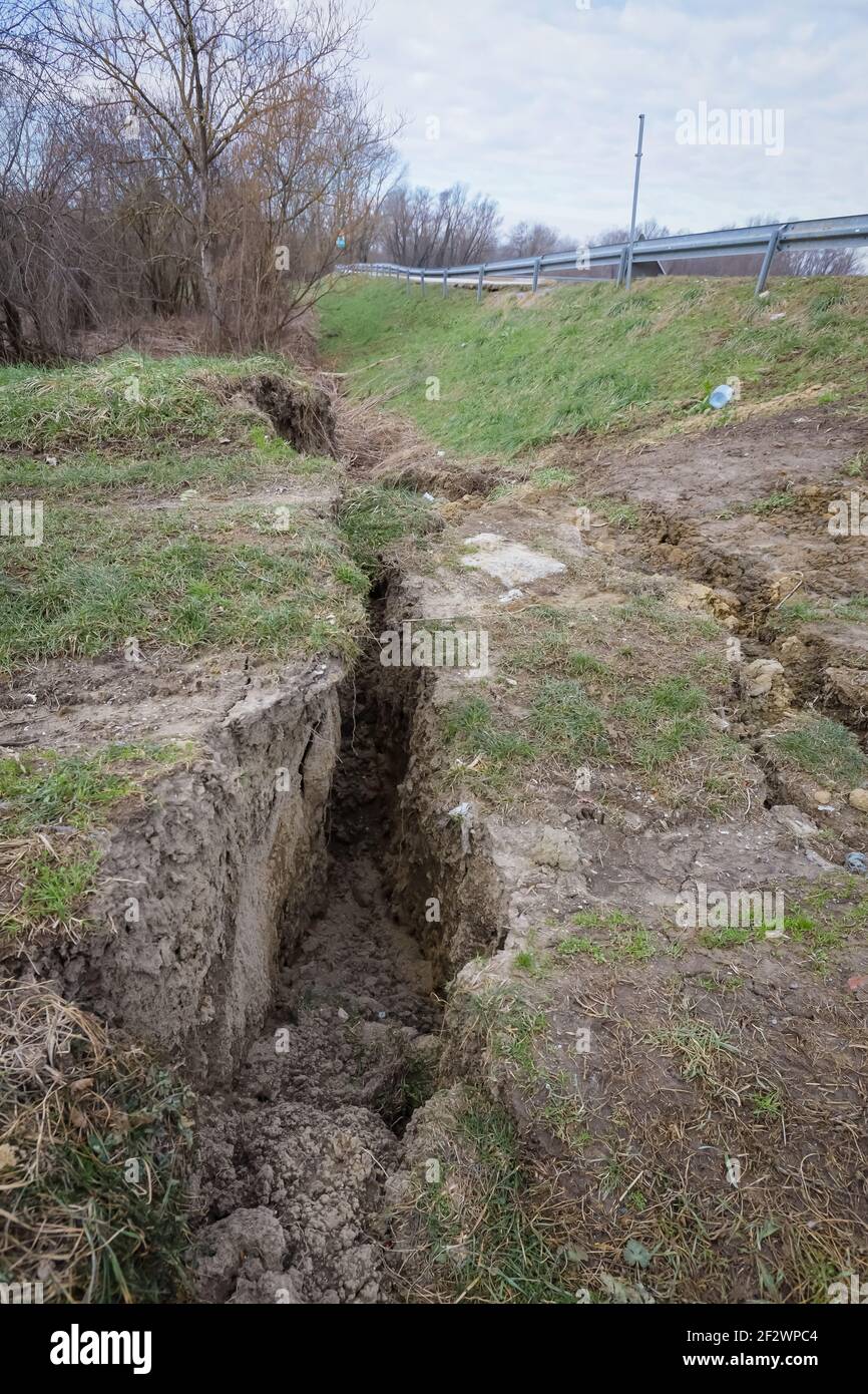 Large crater in the ground after a strong earthquake of magnitude 6.2 ...