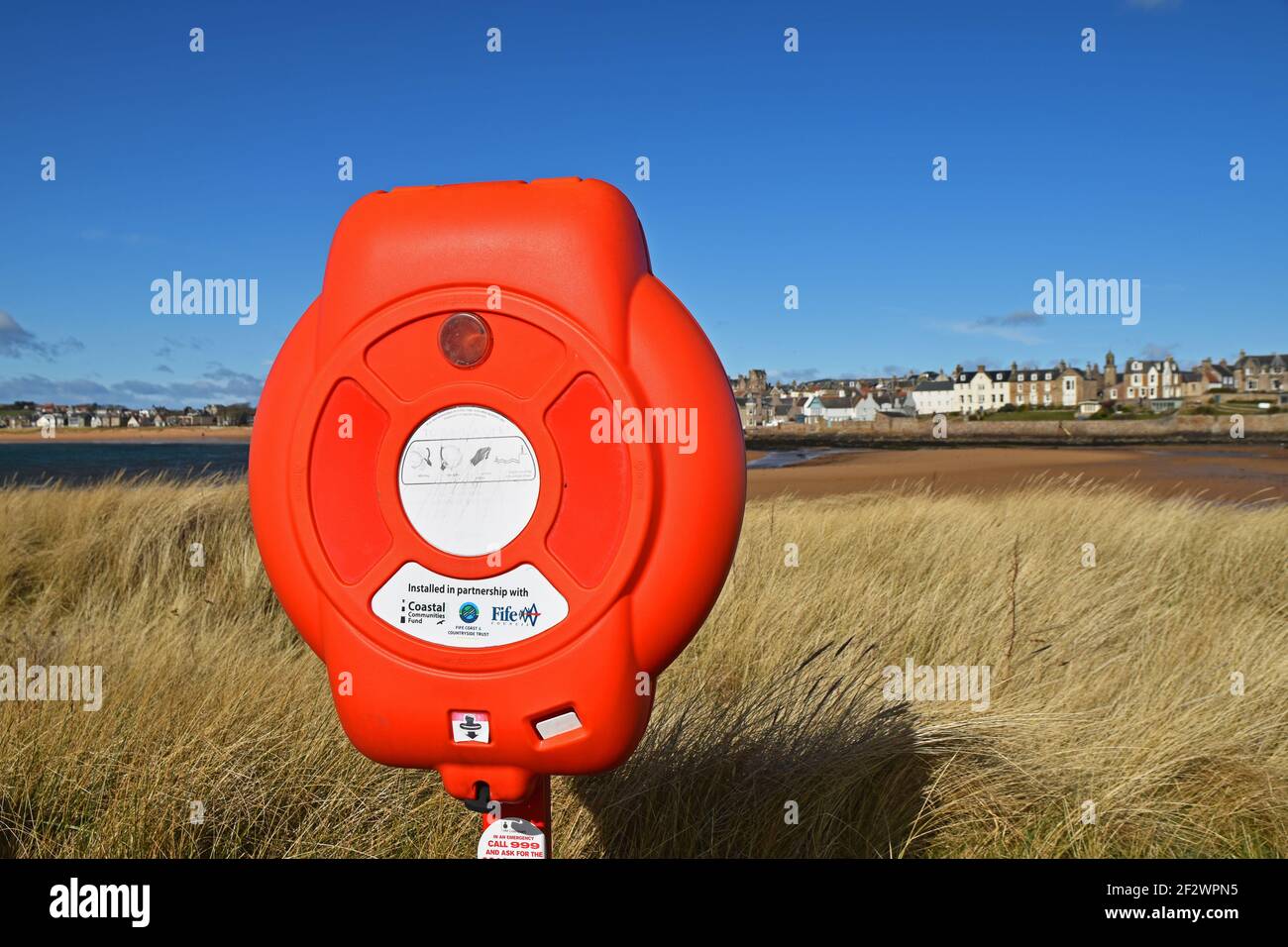 Red life saving equipment box on beach at Elie in Fife, Scotland on a ...