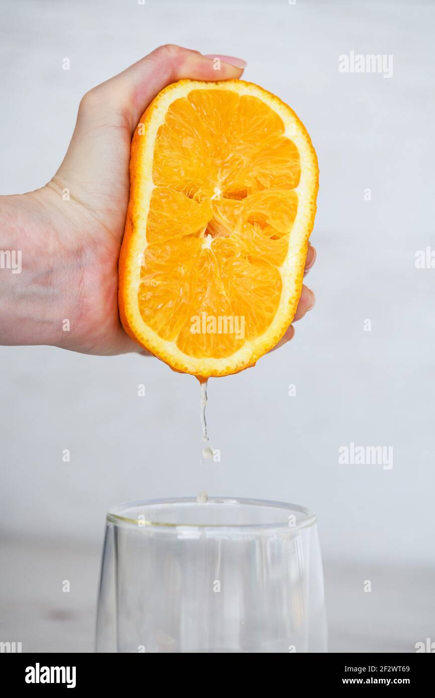 Hand squeezing orange juice hi-res stock photography and images - Alamy