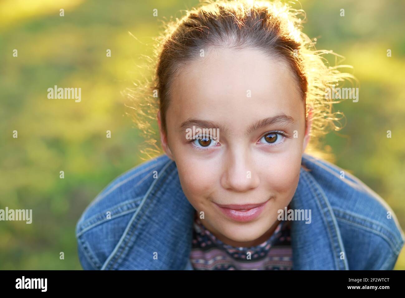 Beautiful teenager girl with happy facial expression looking at camera ...