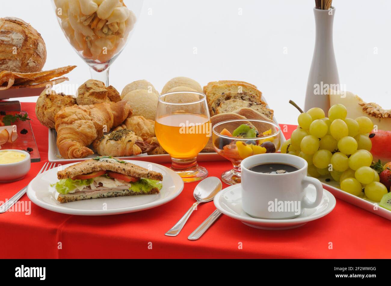 Gastronomy. Breakfast table with cup of coffee, sandwich, fruits, juice ...