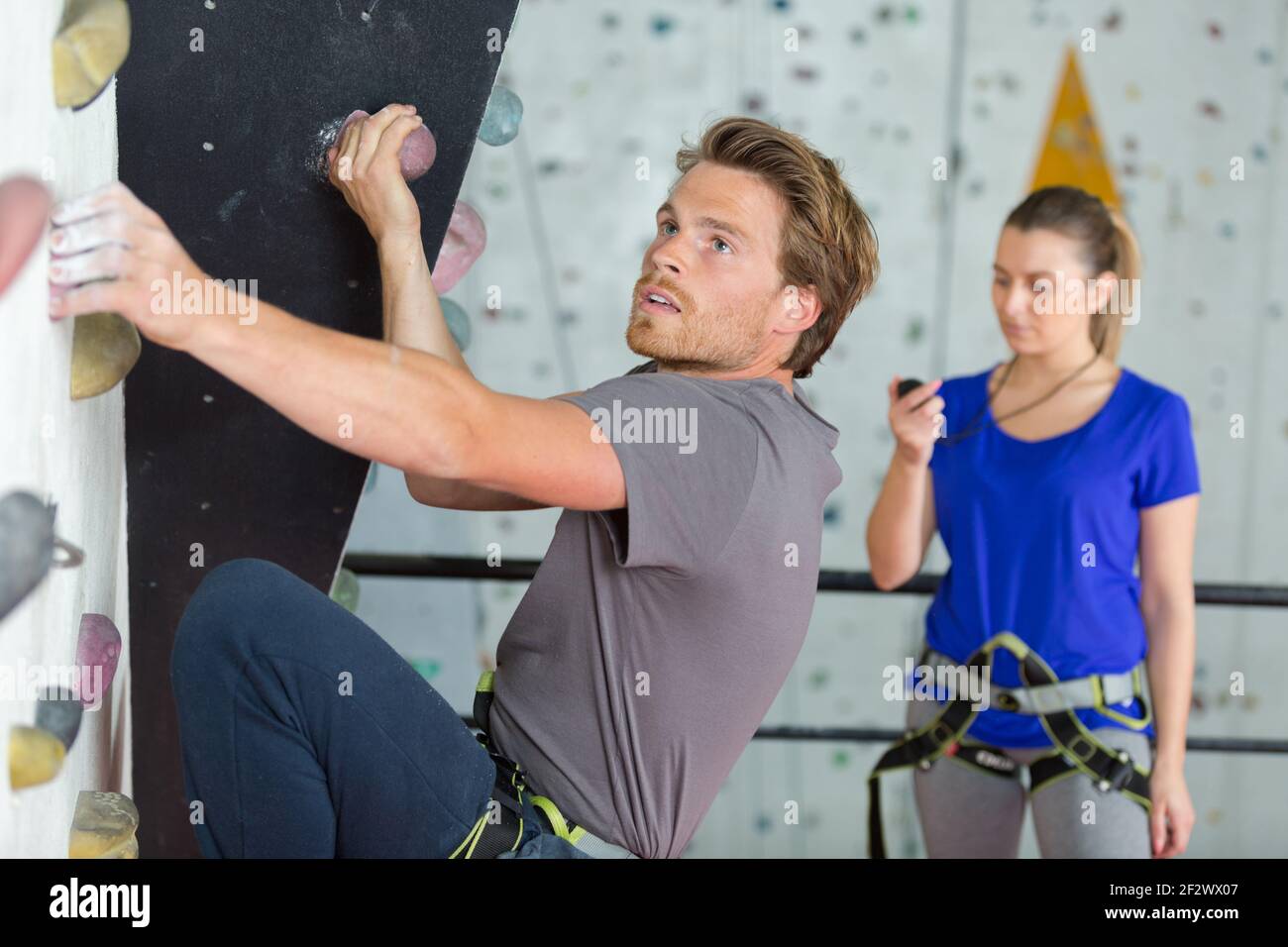 climbing a rock wall indoor Stock Photo - Alamy